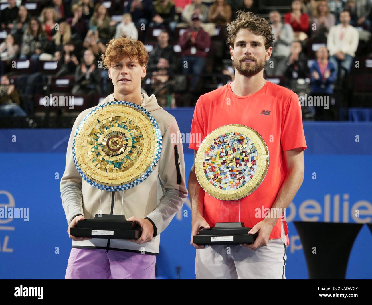 Jannik Sinner (ITA) with the winner's trophy and Maxime Cressy (USA ...