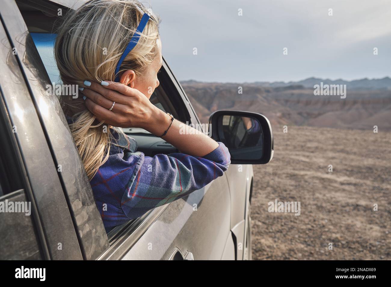 Woman looks out of the car window and admires of the Grand Canyon Stock ...