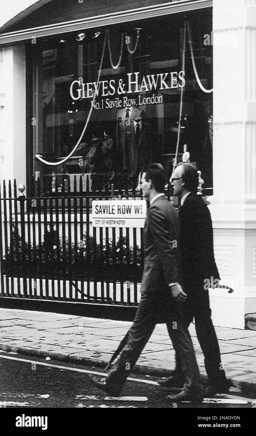 Two umbrella-toting gents walk down Savile Row in London, July 6, 1987 ...
