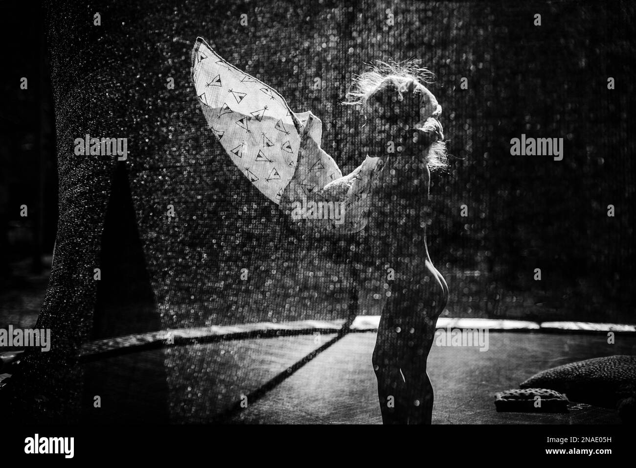 Carefree young child playing on trampoline in beautiful light Stock ...