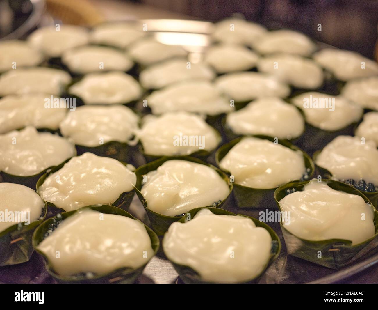 Thai desert ,Famous Thai Pudding with Coconut topping on banana leaf ...