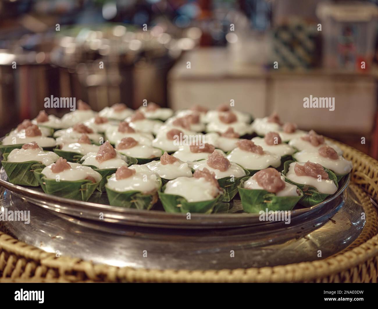Thai desert ,Famous Thai Pudding with Coconut topping on banana leaf ...