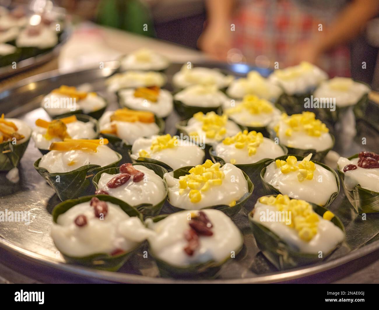 Thai desert ,Famous Thai Pudding with Coconut topping on banana leaf ...