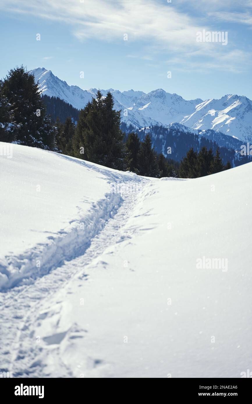 Mountain narrow path covered with snow near the mountain range Stock ...