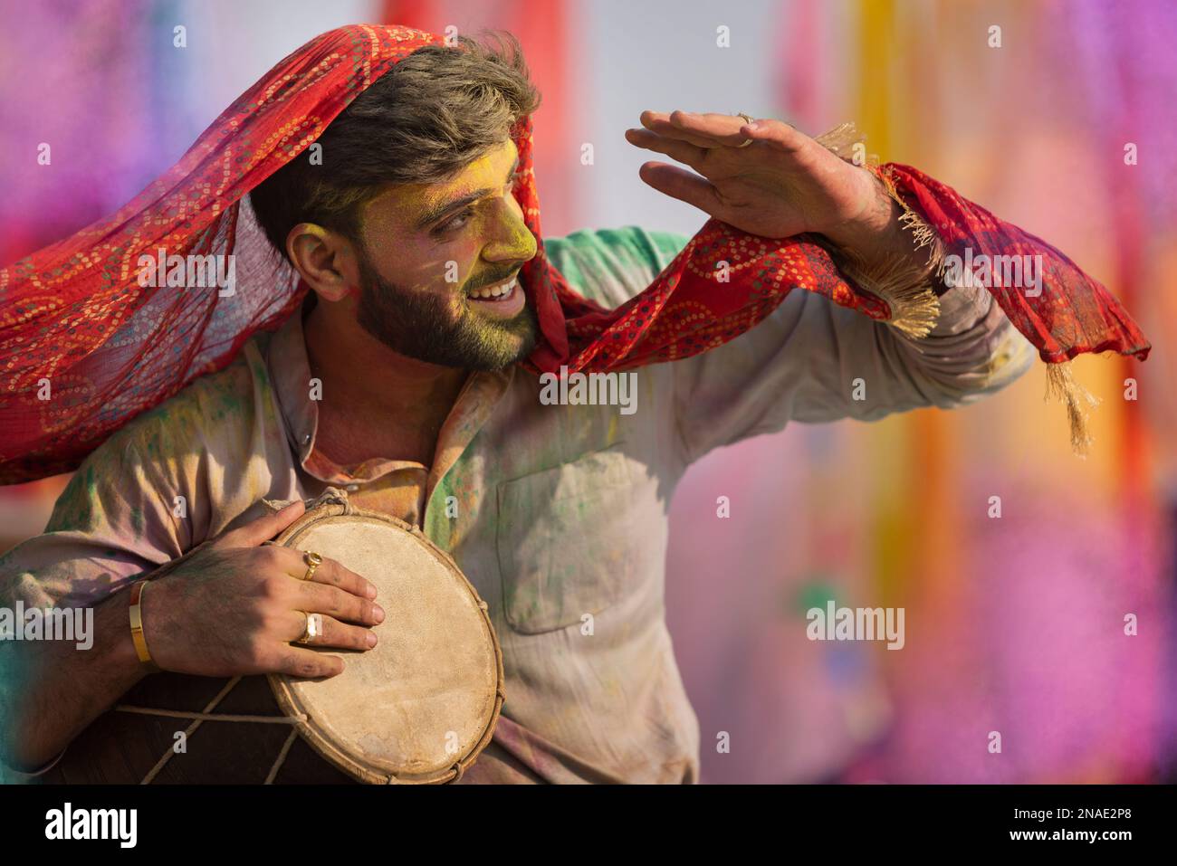 man is playing dhol with colored face during holi color festival Stock ...