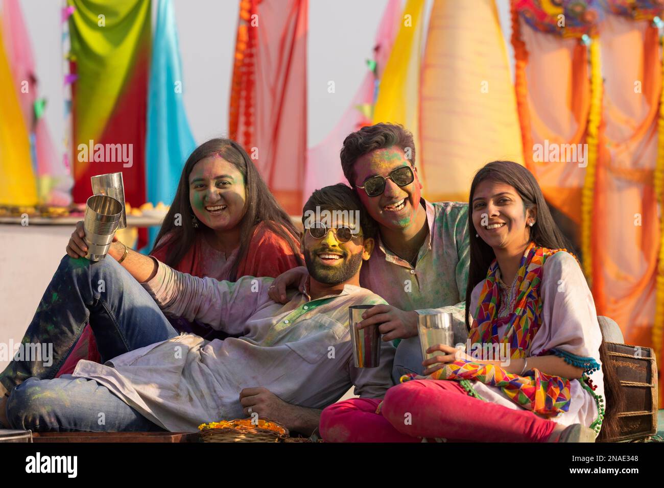 a group of friends sitting while drinking bhang on holi Stock Photo - Alamy