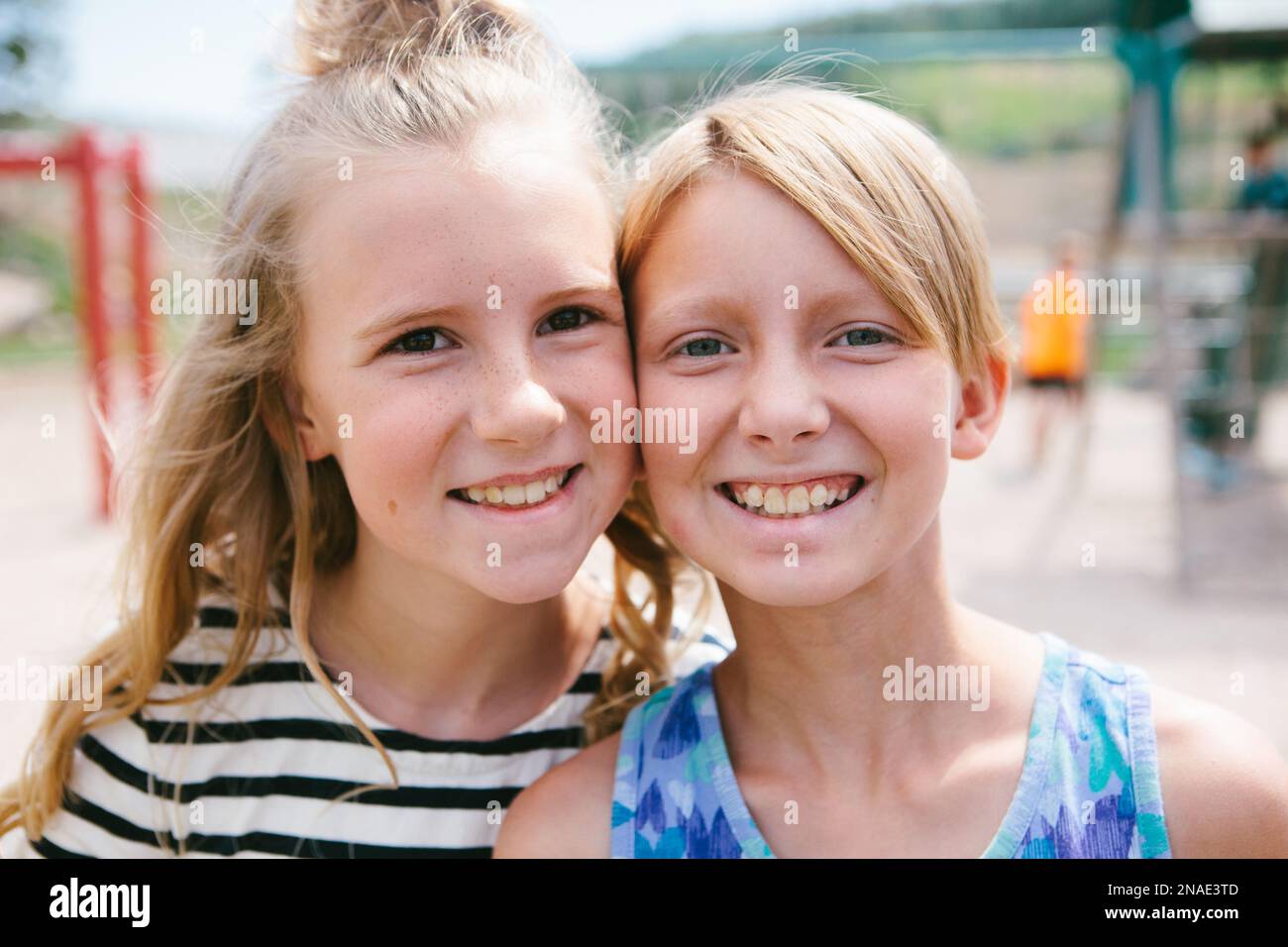 Tween friends with faces together happy and smiling outside Stock Photo ...