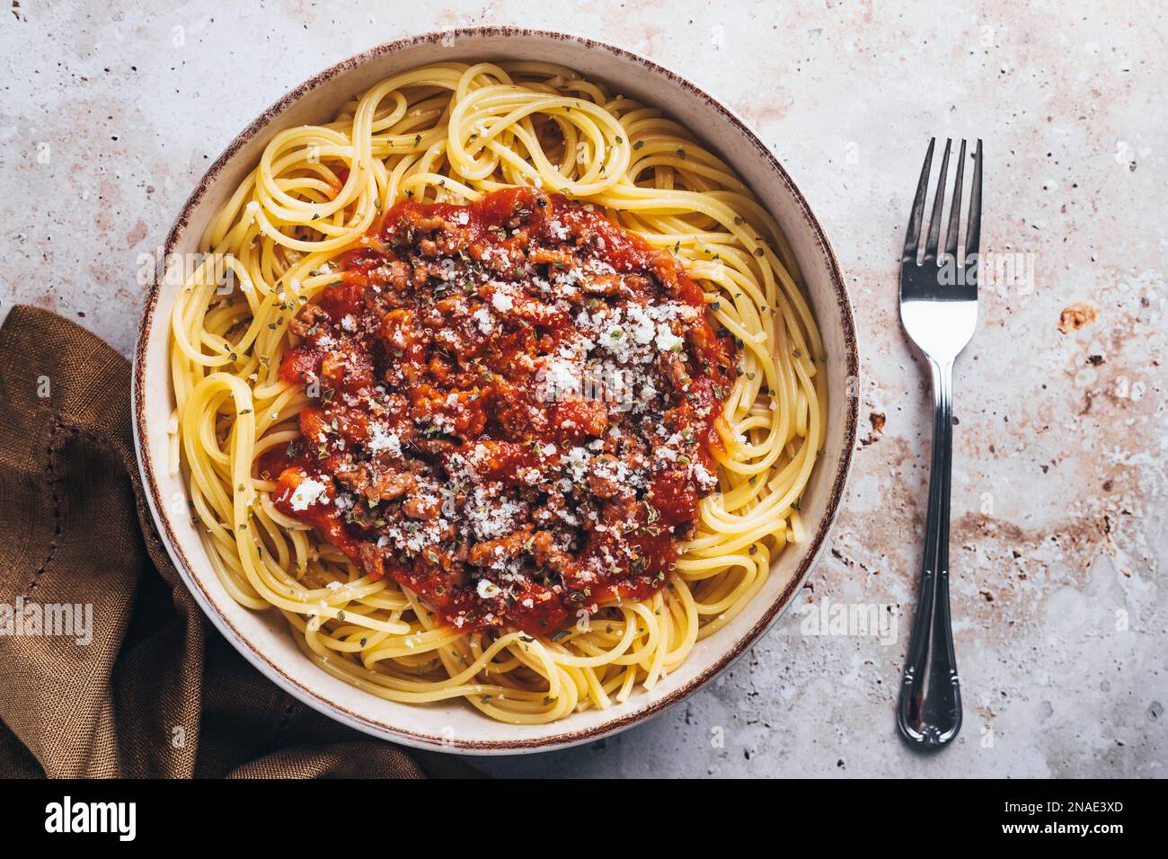 Flat lay view of spaghetti with bolognese sauce on stone background ...