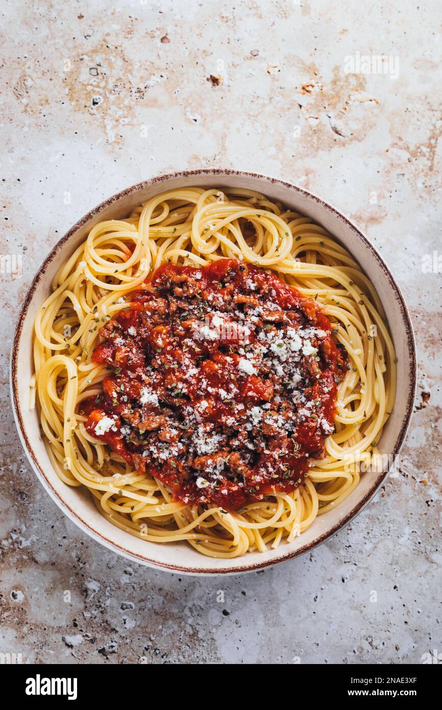 Flat lay view of spaghetti with bolognese sauce on stone background ...
