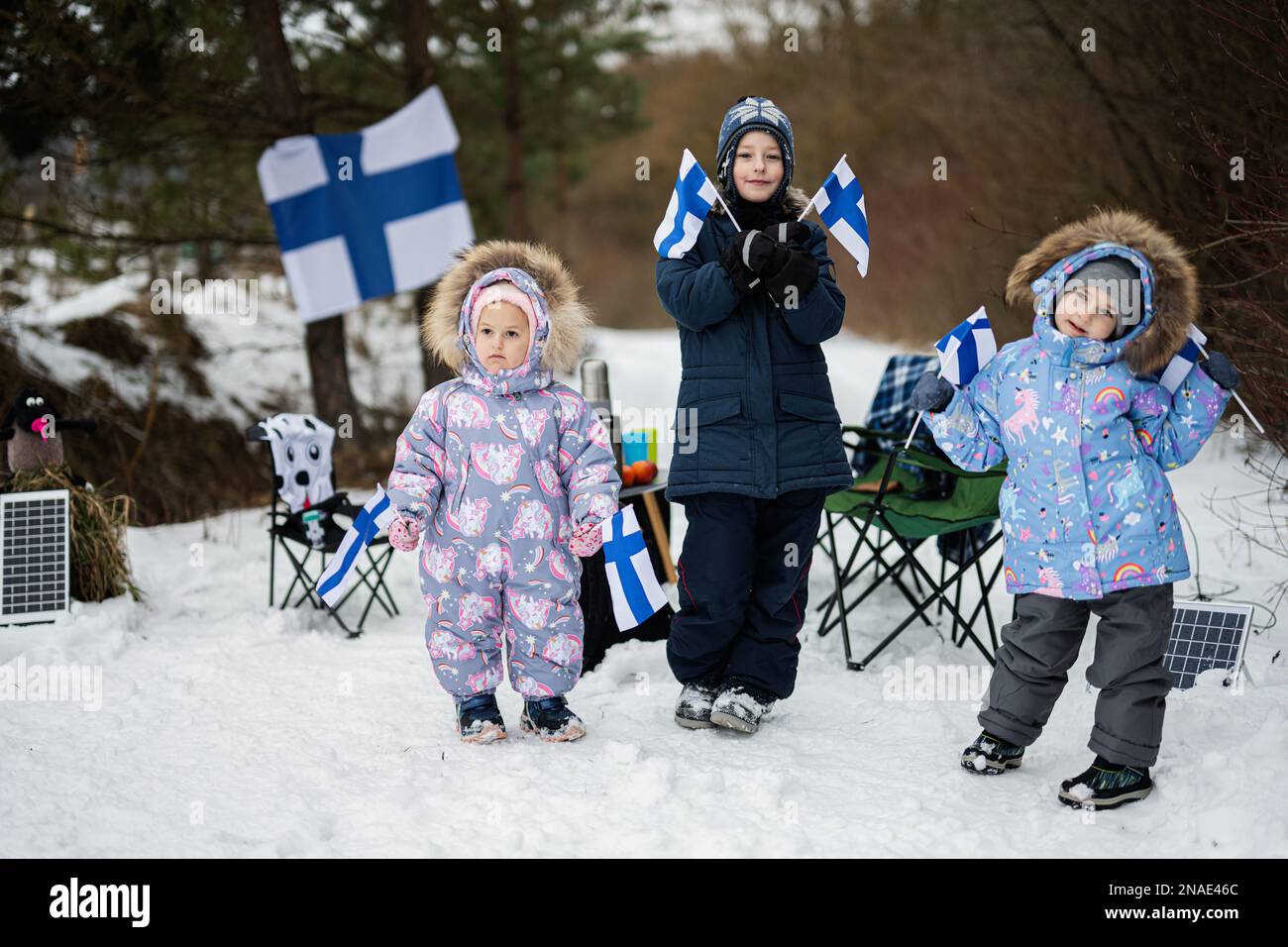 Three finnish children with Finland flags on a nice winter day. Nordic ...