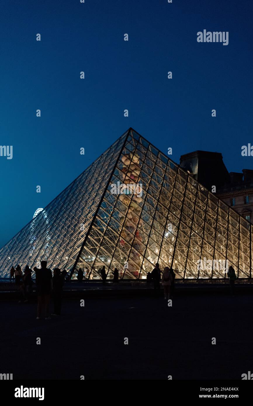 The Louvre crowds at night Stock Photo - Alamy