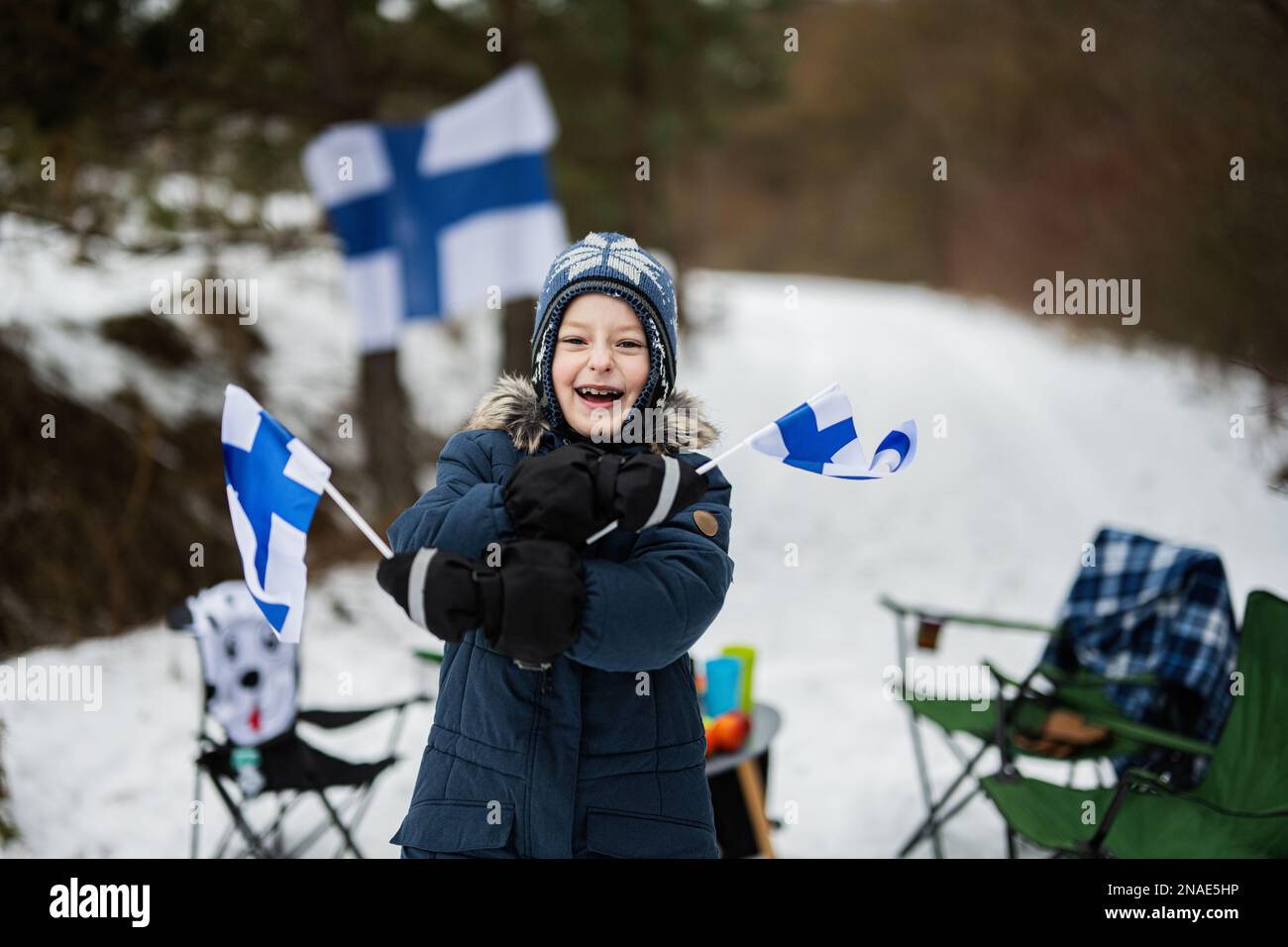 Finnish boy with Finland flags on a nice winter day. Nordic ...