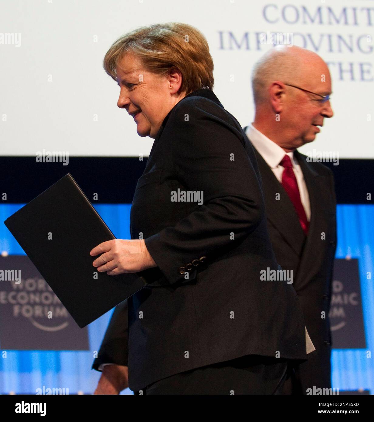 German Chancellor Angela Merkel, left, is welcomed by Klaus Schwab, the ...