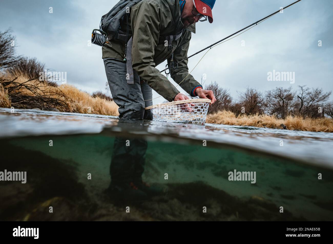 Fisherman unhooking fish hi-res stock photography and images - Alamy