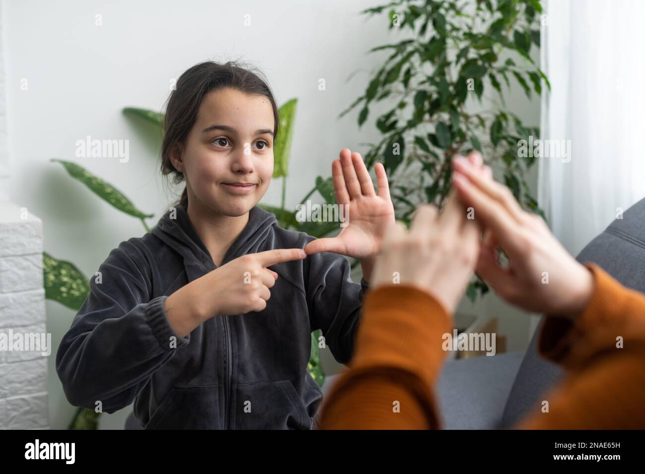Small Caucasian teen girl child do articulation exercises with caring ...