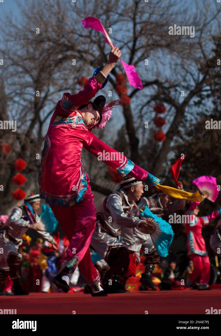 Chinese folk dance artists dressed in traditional costumes participate ...