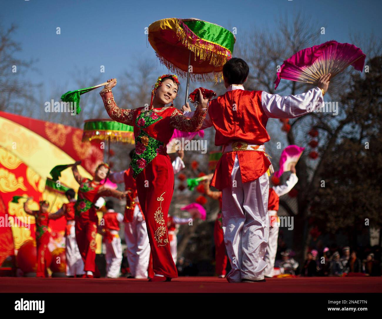 Chinese performers dressed in traditional costumes participate in a ...