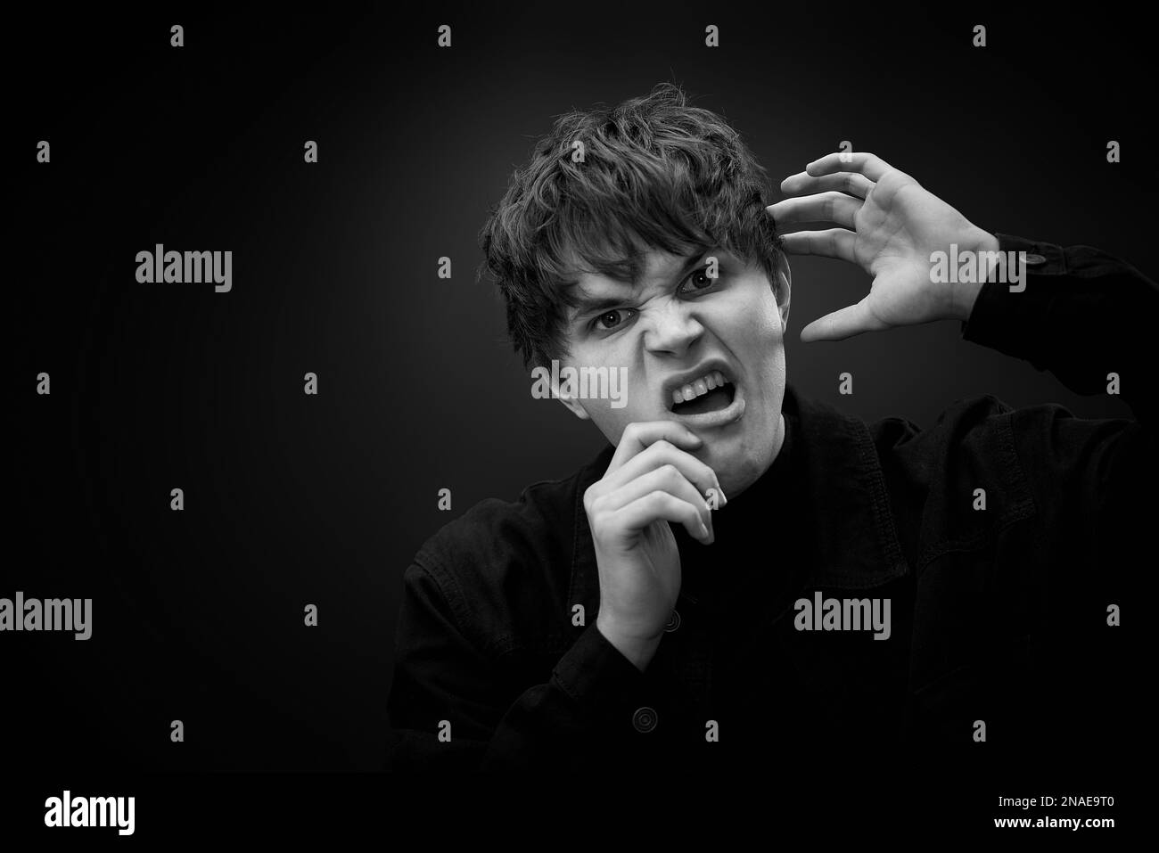 crazy young man with awesome hairdo grimacing Stock Photo - Alamy