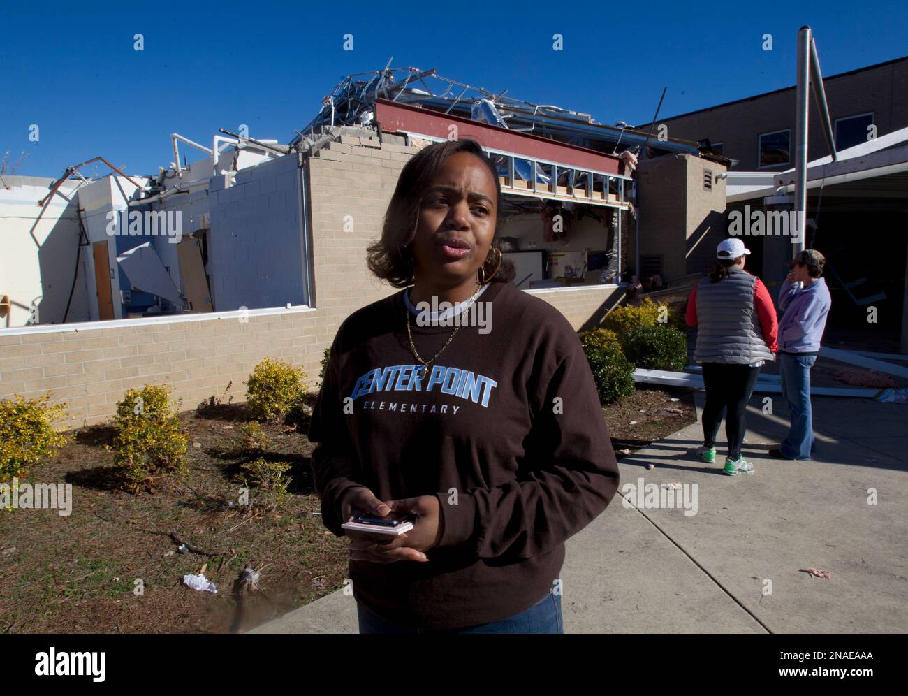 Second grade teacher Monica Finley stands outside the heavily damaged ...