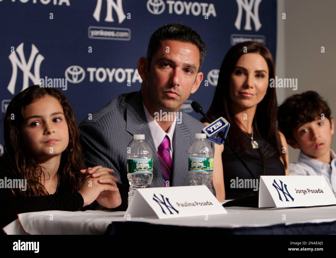 New York Yankees baseball player Jorge Posada, second from left, sits ...