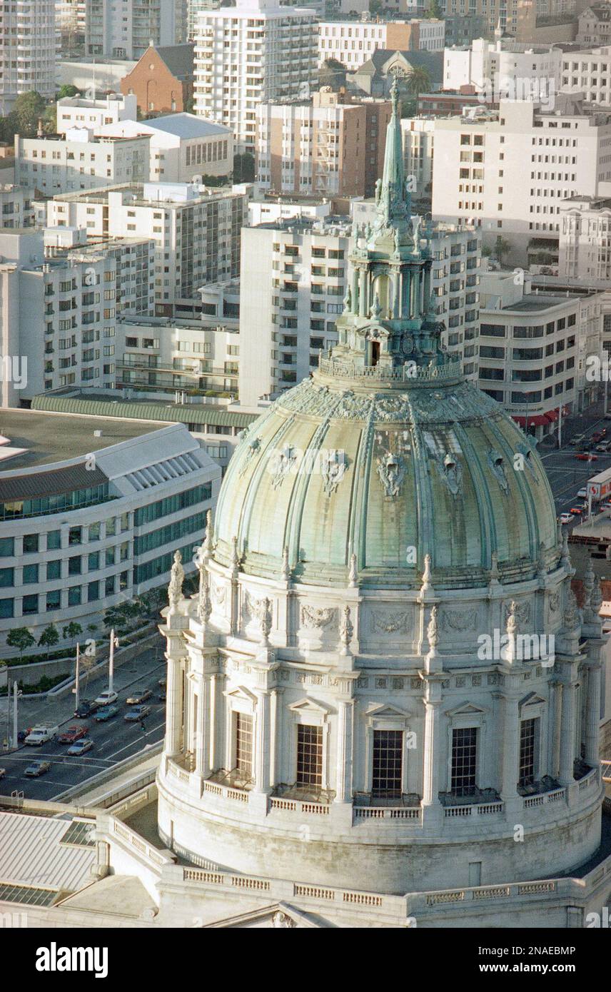 The dome of San Francisco's historic City Hall reflects the light of ...