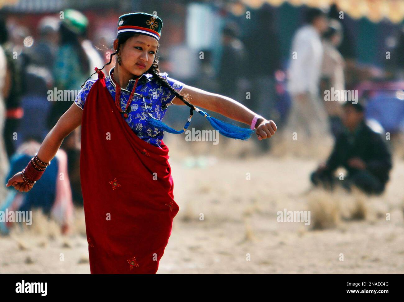 A Nepalese Tamang community young girl in traditional attire dances to ...