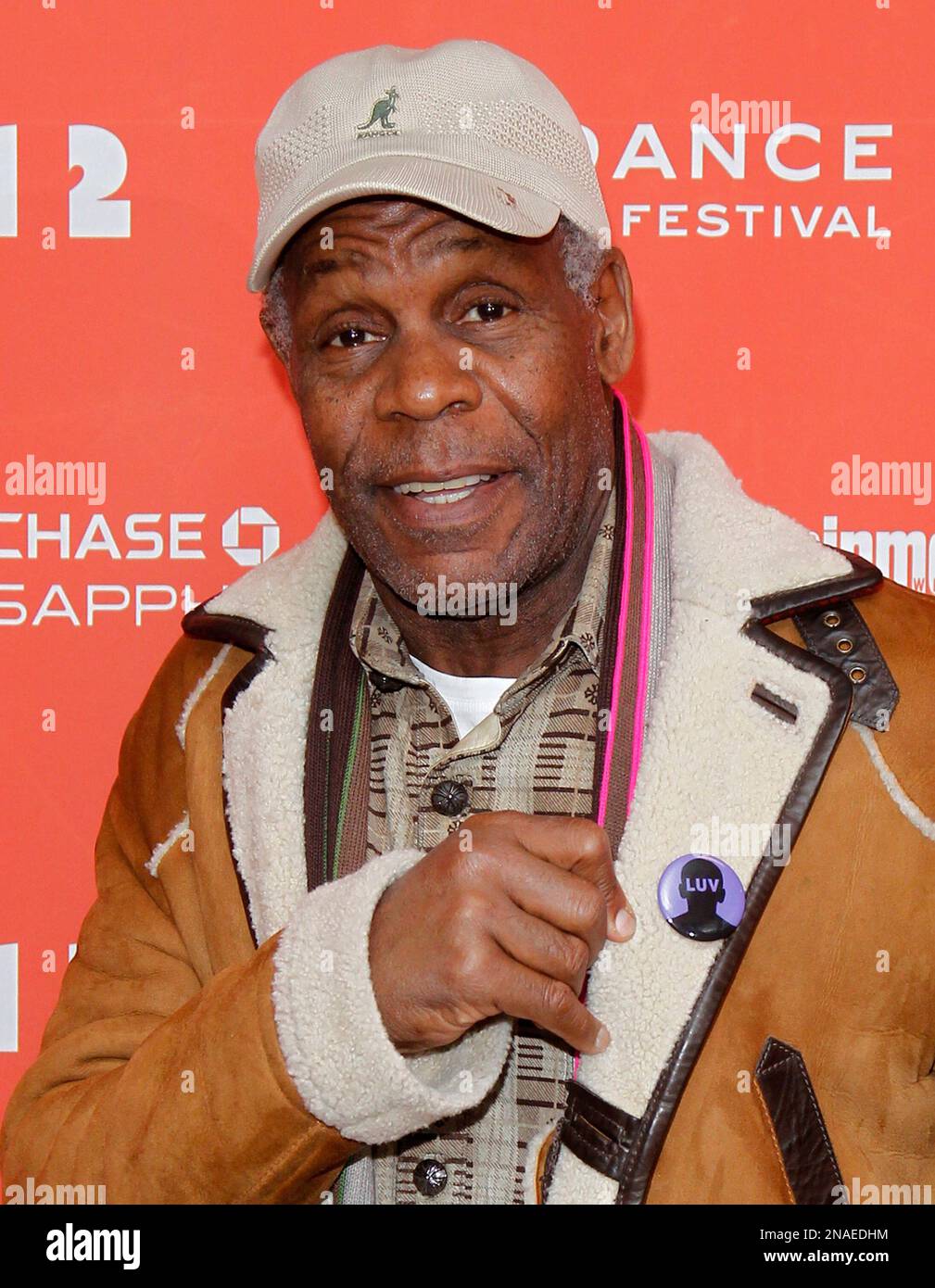 Actor Danny Glover shows a button promoting the film as poses at the ...