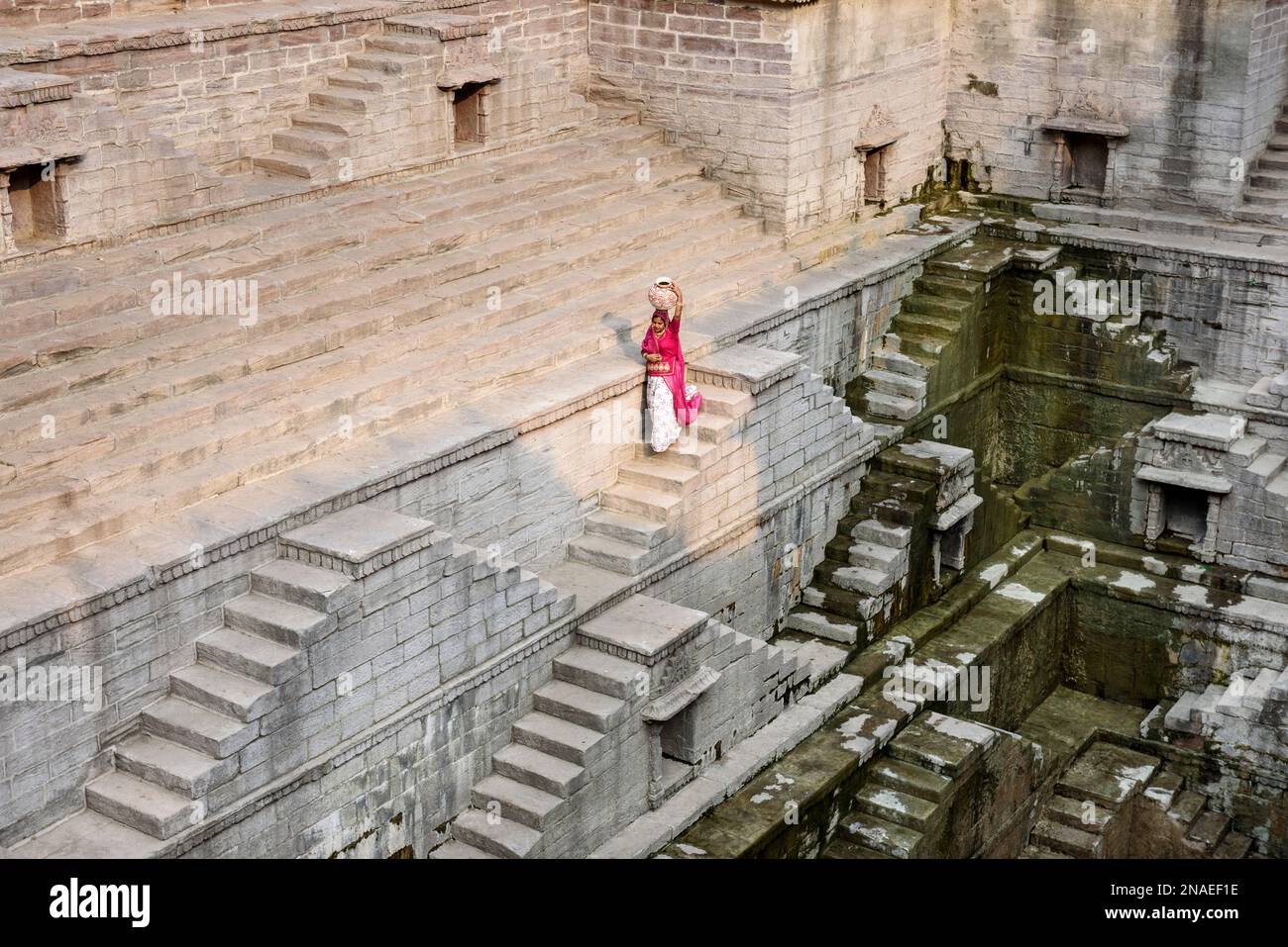 Woman collecting water from step well Stock Photo - Alamy