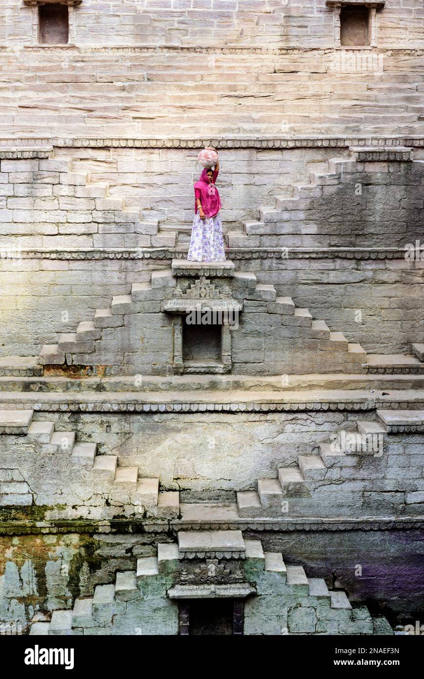 Woman collecting water from step well Stock Photo - Alamy