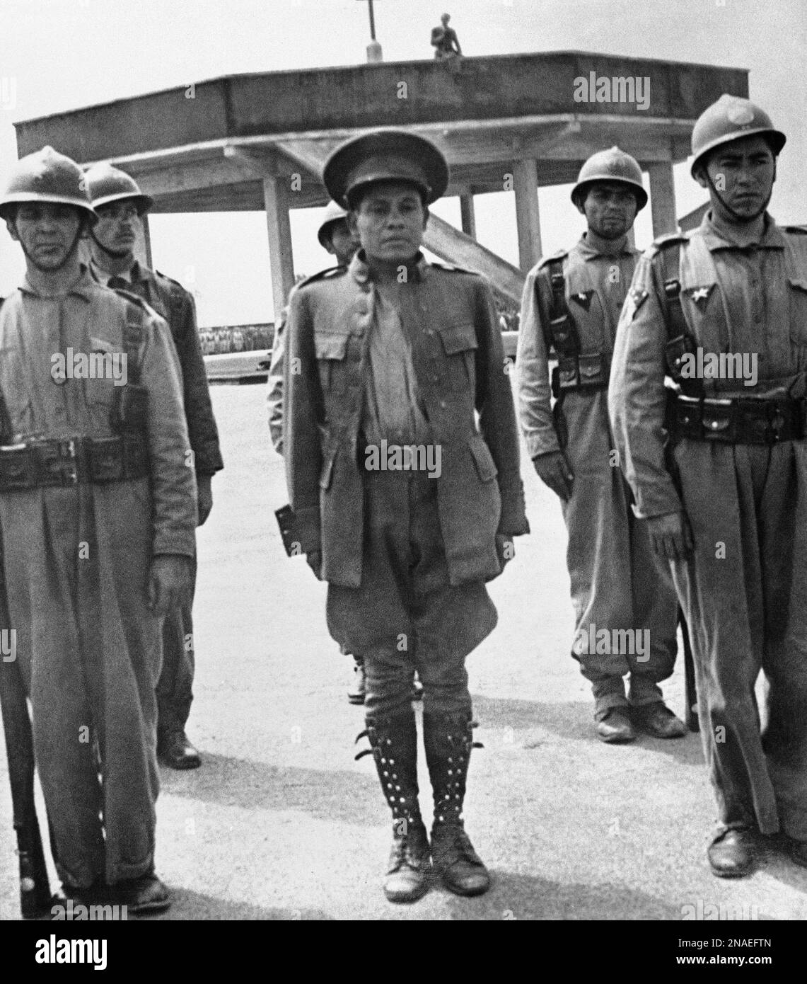 Benito Castaneda Chavarria, his buttonless coat hanging open and ...