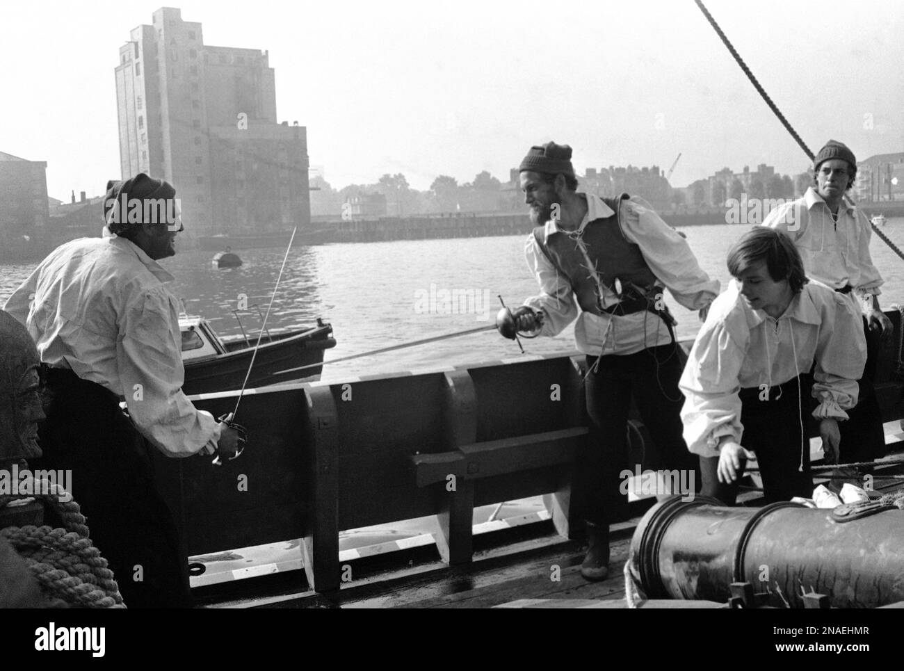 Chris Daniel, from England, stages a mock sword fight with another crew ...