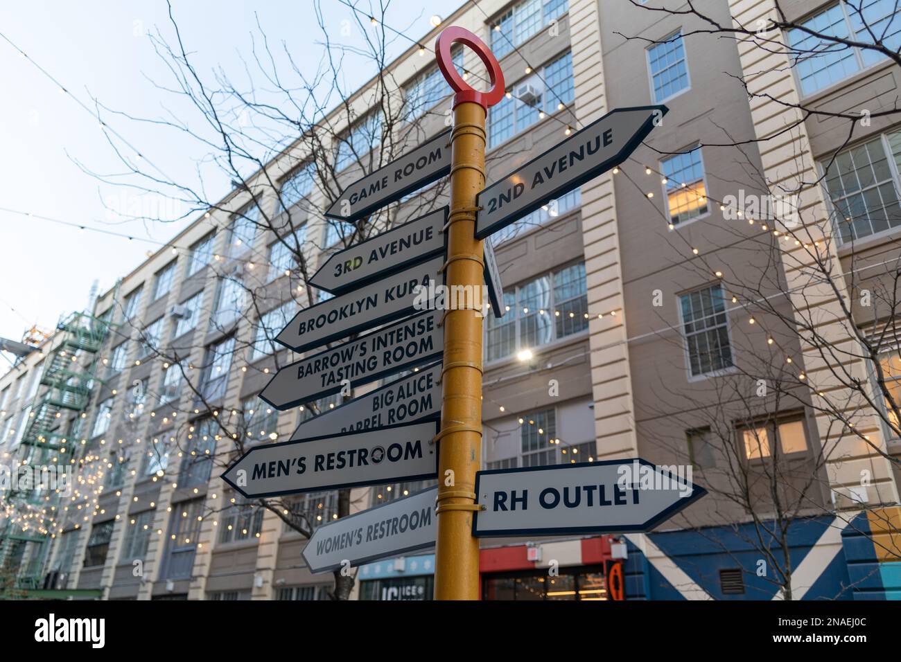 A street corner next to buildings that have signs pointing in two ...