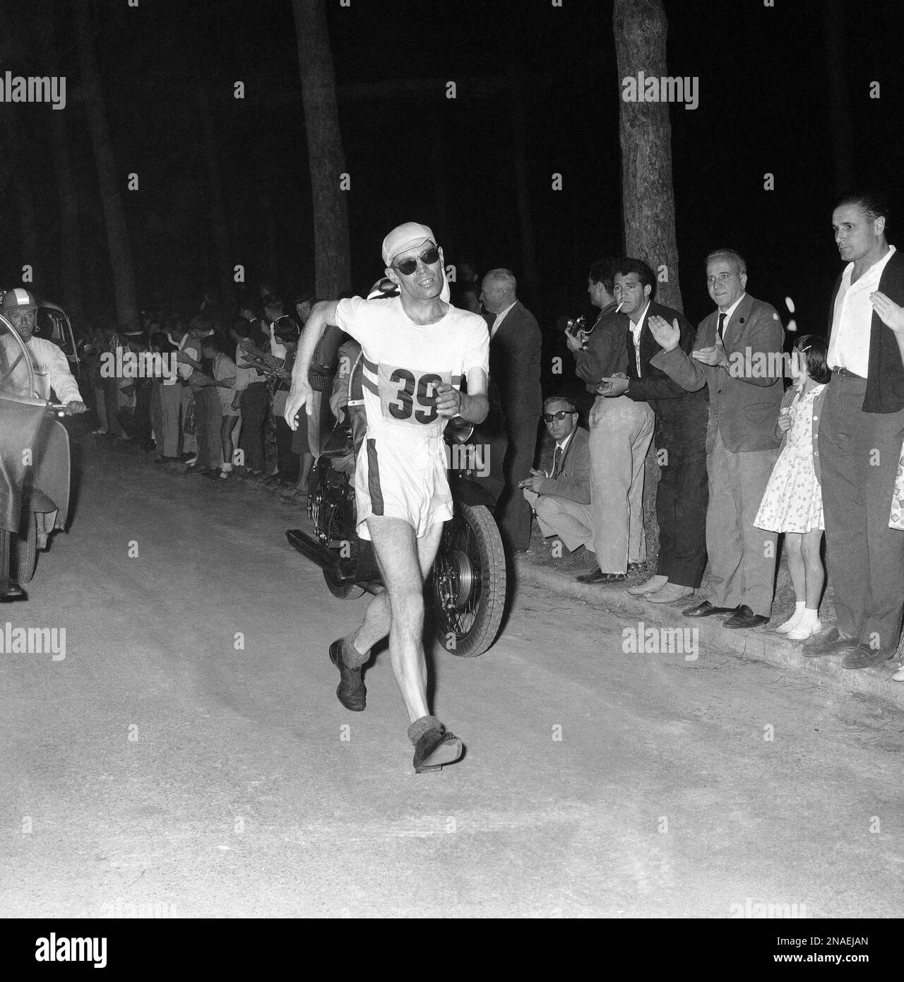 Don Thompson of Great Britain swings along towards the Olympic Stadium ...