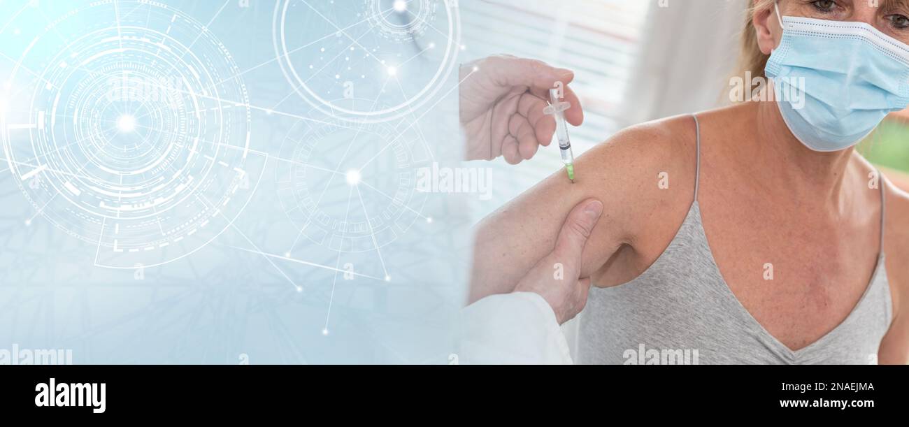 Doctor giving vaccin injection to female patient in medical office ...