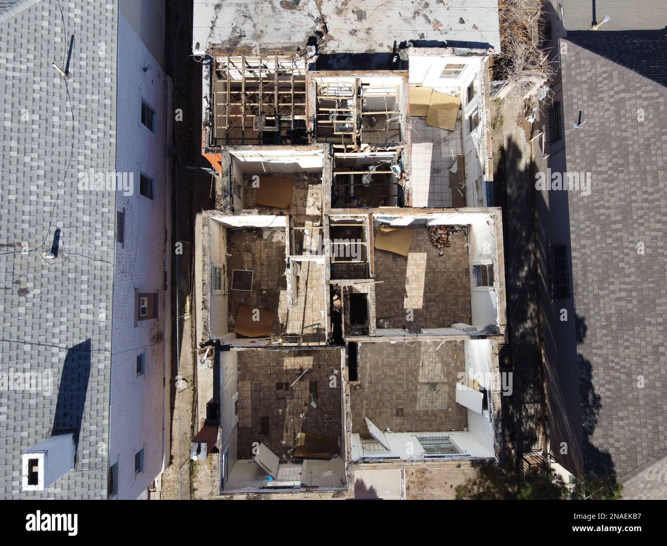 An aerial top view of a dilapidated house with no roof under the sun ...