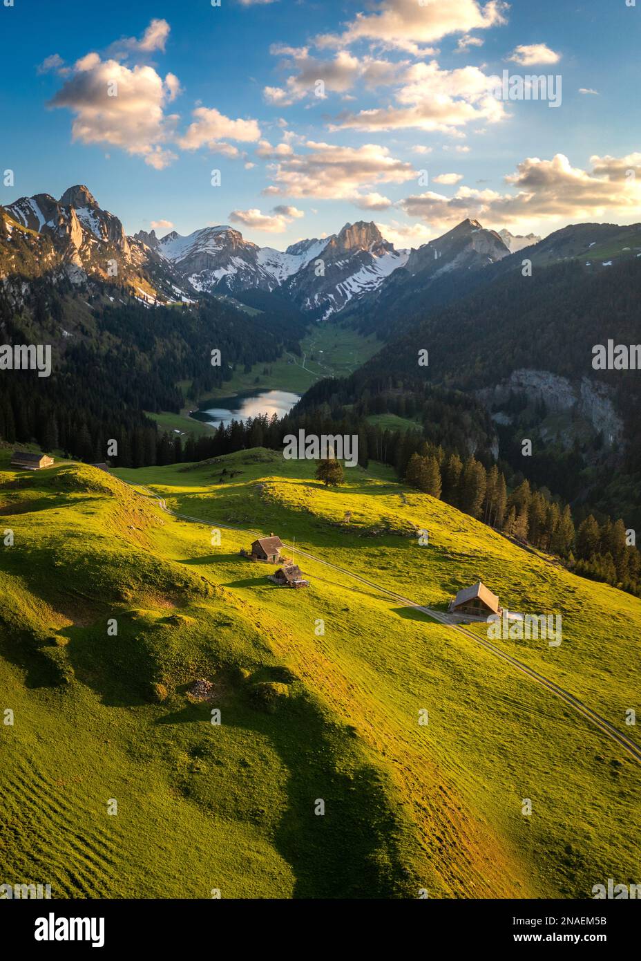 A farm in the valley next to a mountain lake Stock Photo - Alamy
