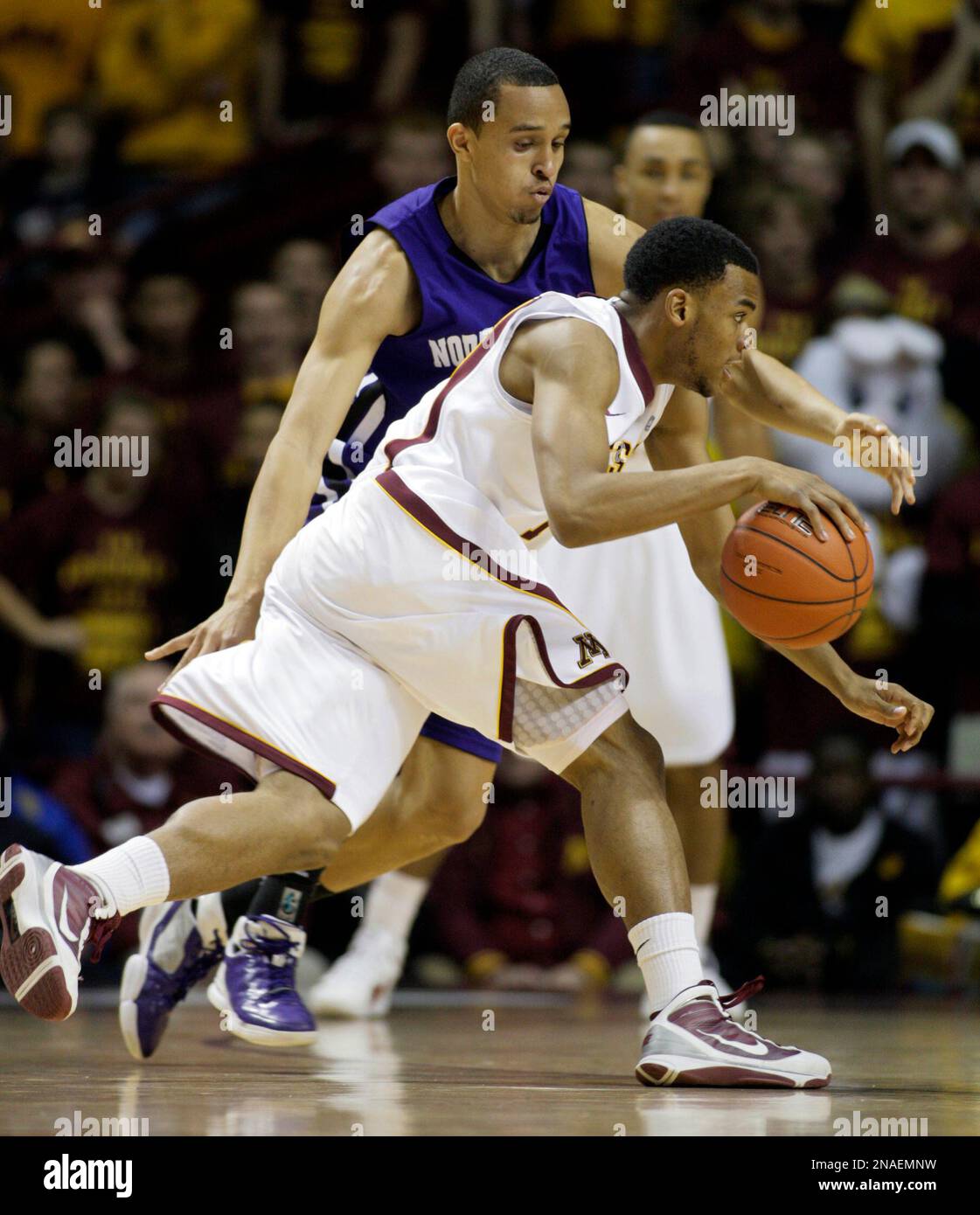 Minnesota guard Joe Coleman (11) drives around Northwestern guard ...
