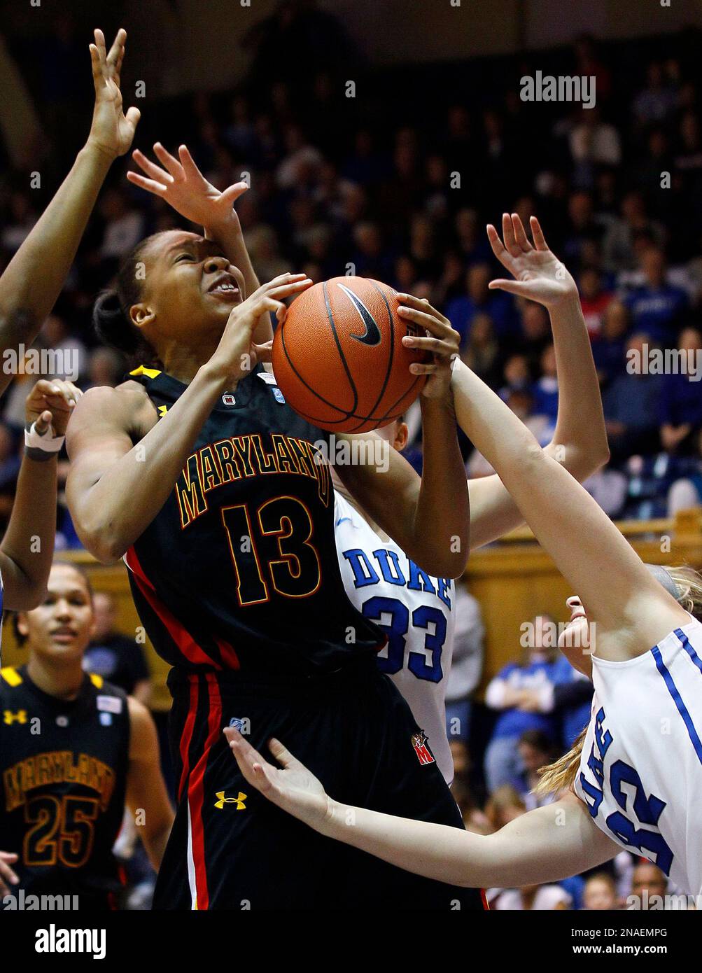 Maryland's Alicia DeVaughn (13) tries to shoot as Duke's Tricia Liston ...