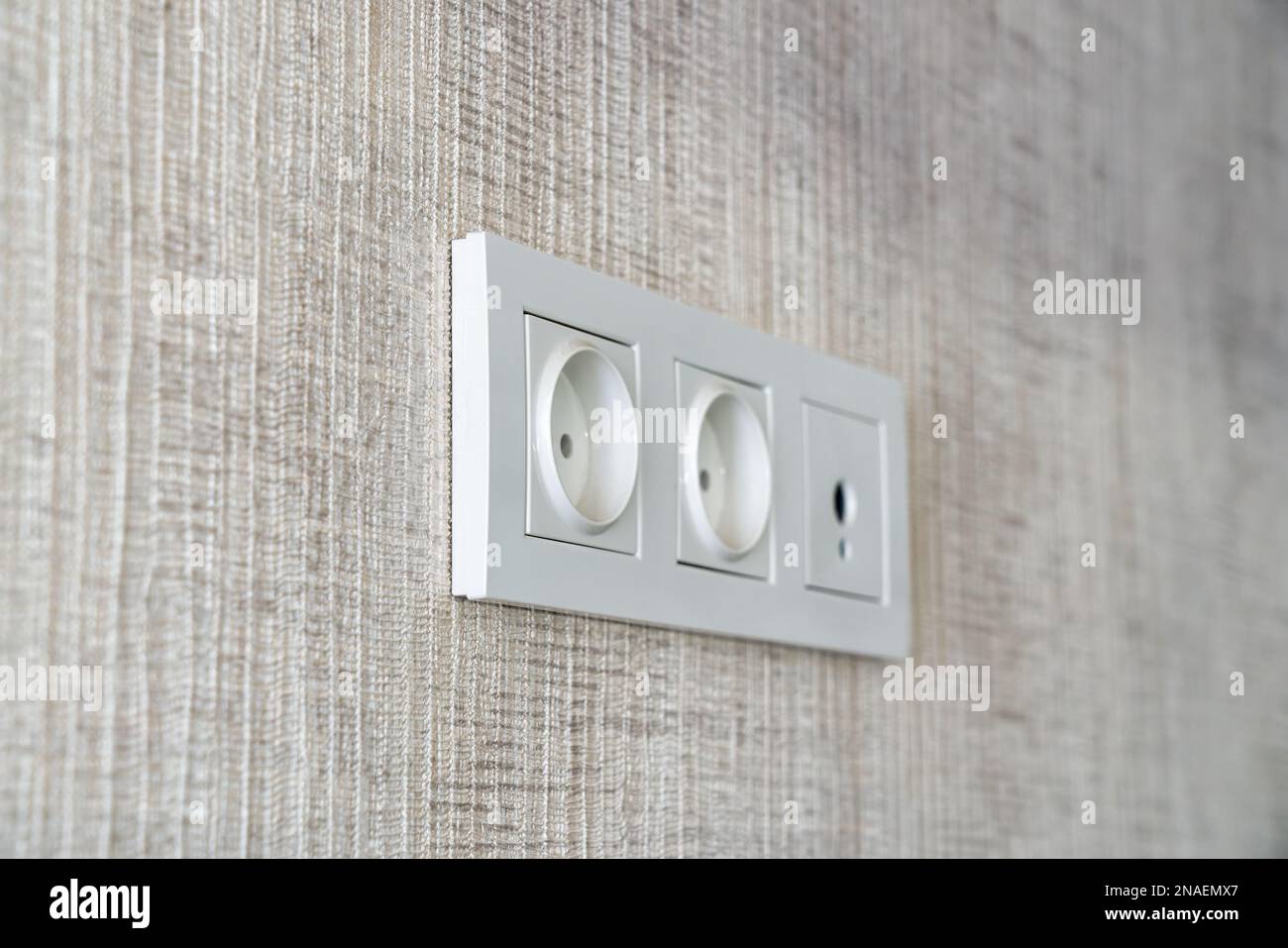 Plastic panel with white electrical sockets and cable connectors on the ...