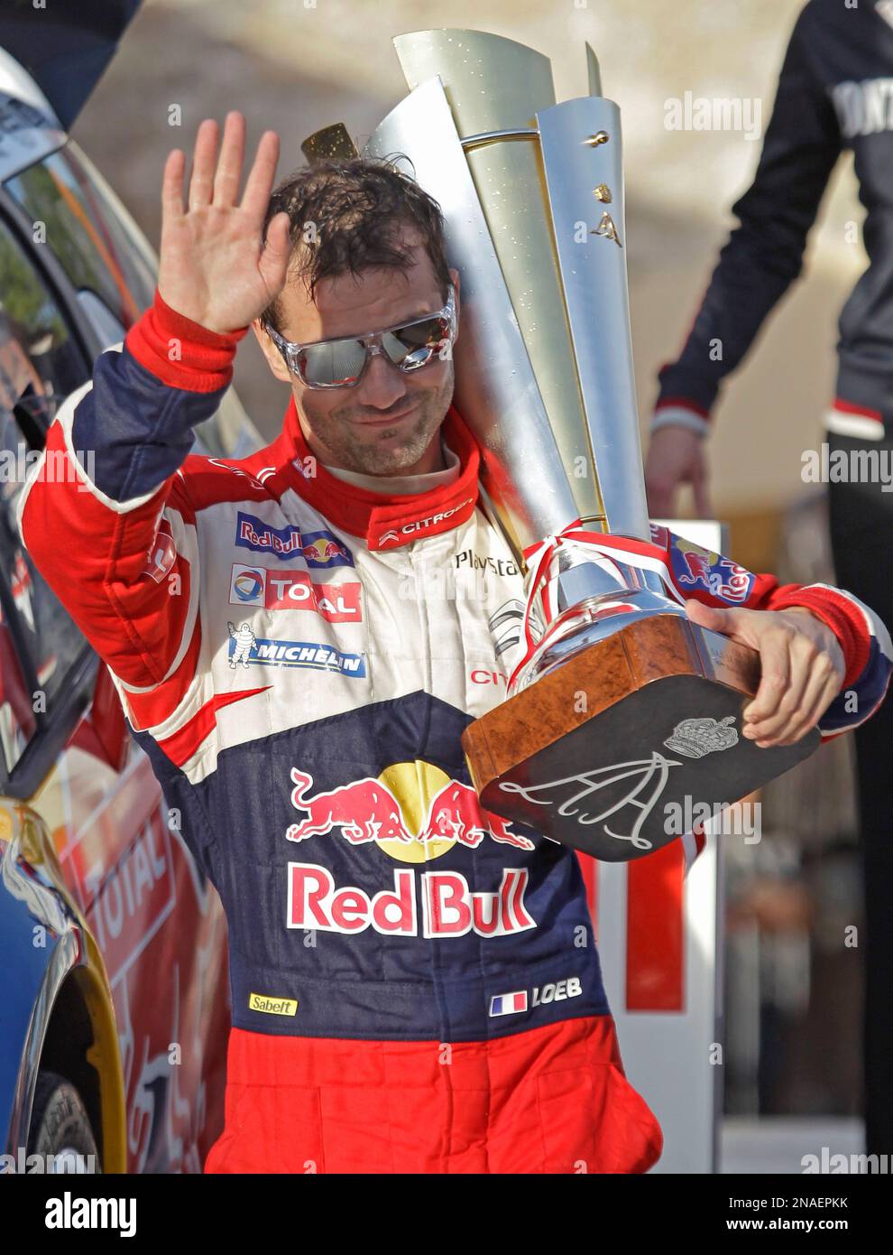 World champion Sebastien Loeb of France holds his trophy after winning ...