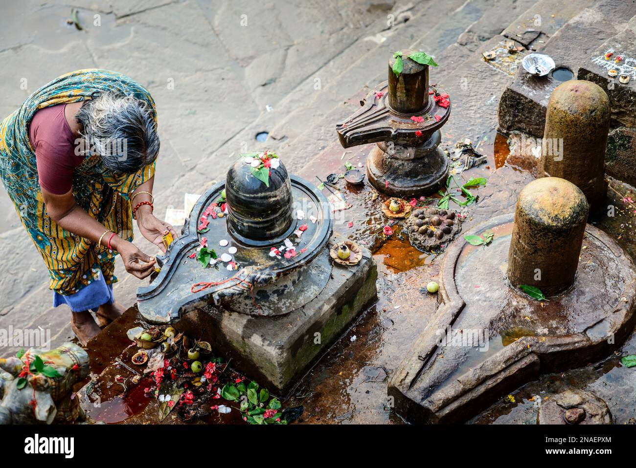 Shiva Linga shrine with devotee Stock Photo - Alamy