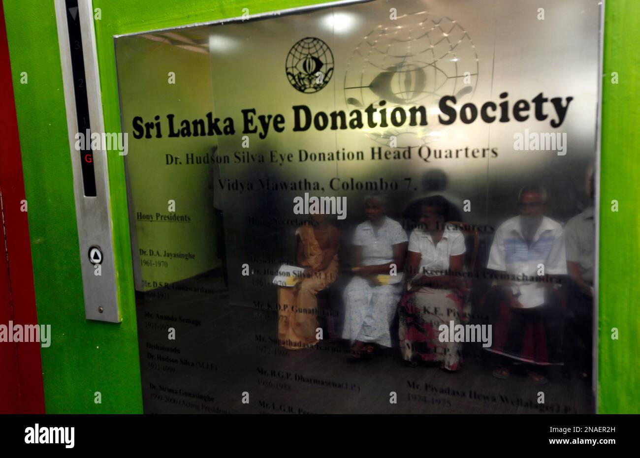 In this Nov. 2, 2011 photo, a group of eye patients are reflected in a ...