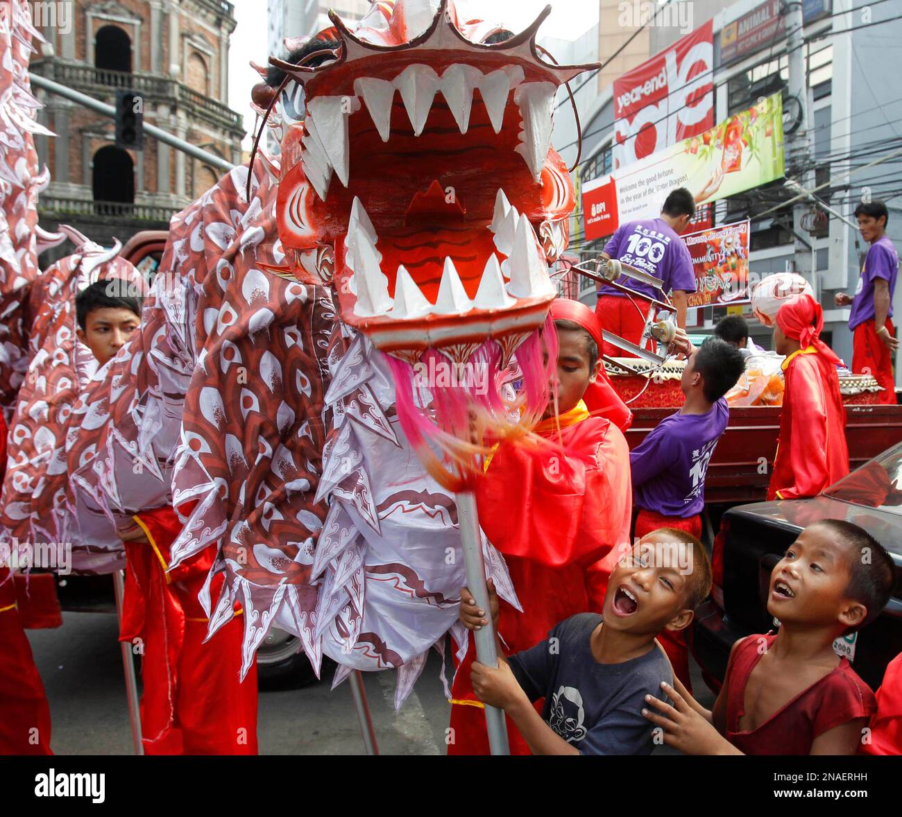 Children admire a huge dragon puppet following a performance by ...
