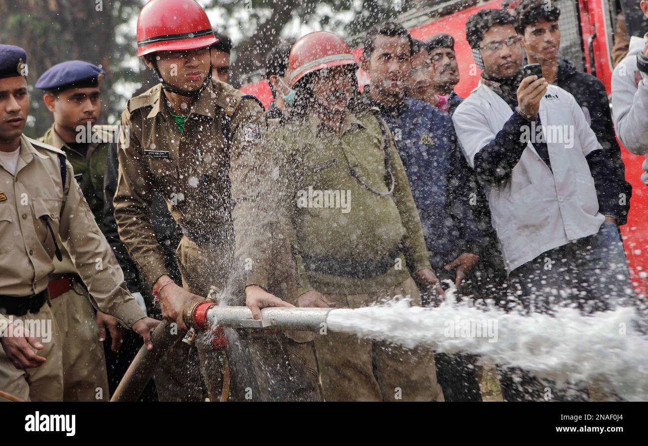 An Indian firefighter tries to extinguish a fire during a fire safety ...