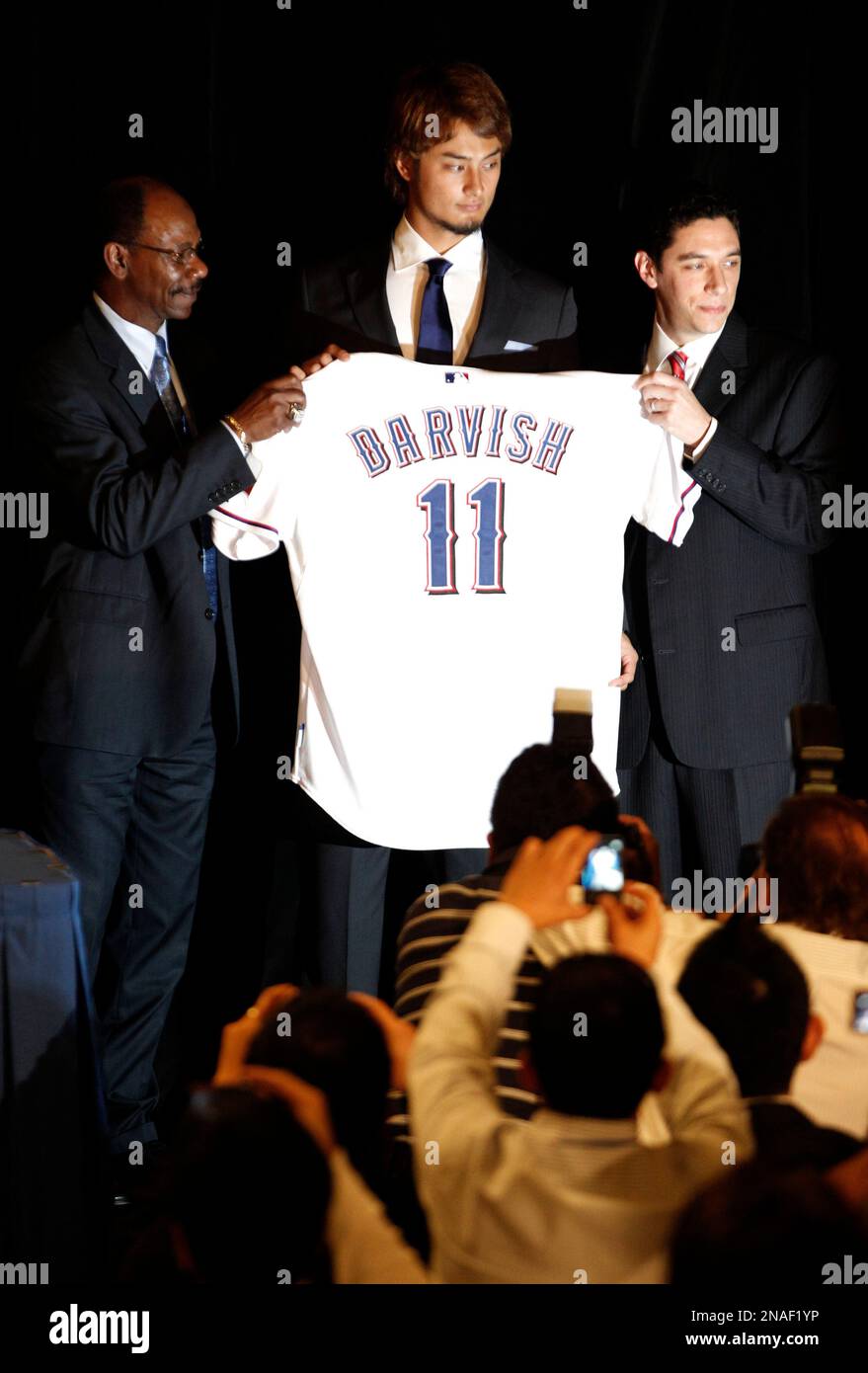 New Texas Rangers pitcher Yu Darvish, center, posses with manger Ron ...