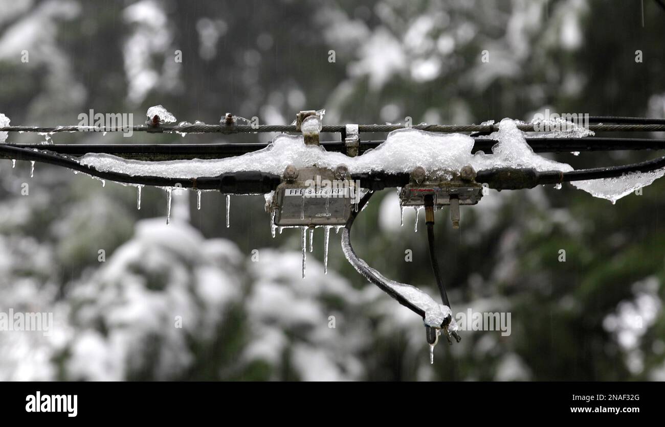 Ice coats TV cable lines, Friday, Jan. 20, 2012, near Lacey, Wash ...
