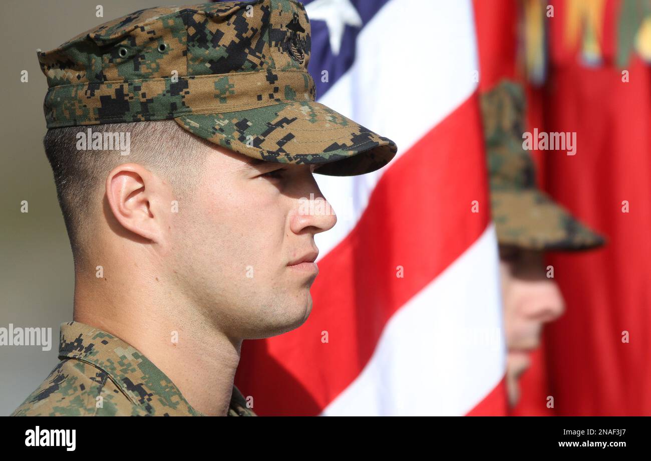 A member of the Marine color guard stands at attention during a ...