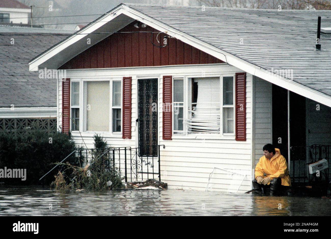 Following a heavy storm, high water surrounds a home on Broad Sound Ave ...