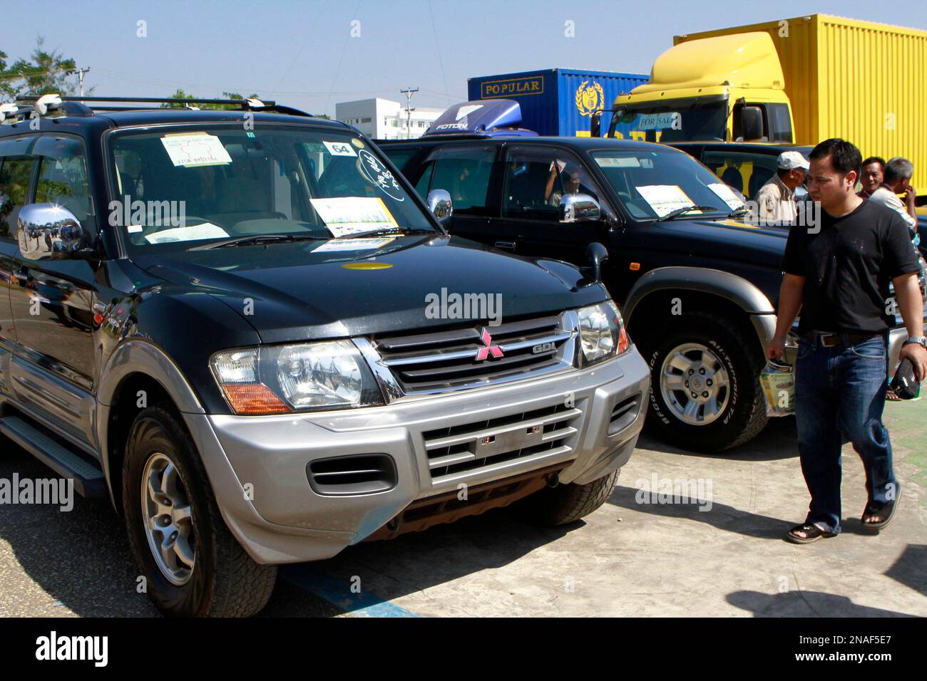 A visitor glances at a Mitsubishi SUV on display at the National Expo ...