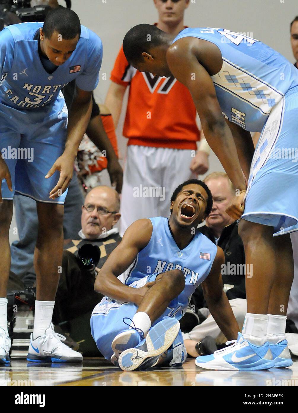 North Carolina's Dexter Strickland (1) holds his leg after an injury as ...